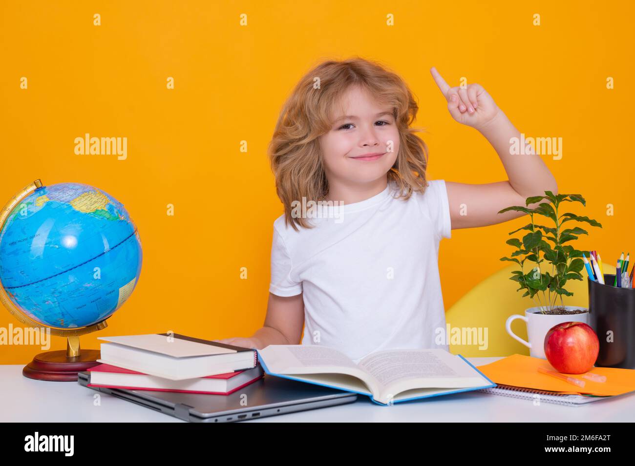 School kid holding index finger up with great new idea. Back to school ...