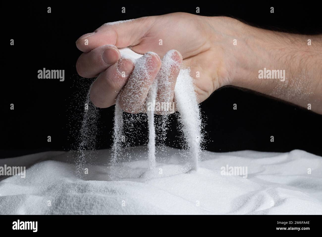 Sand flowing through hand hi-res stock photography and images - Alamy