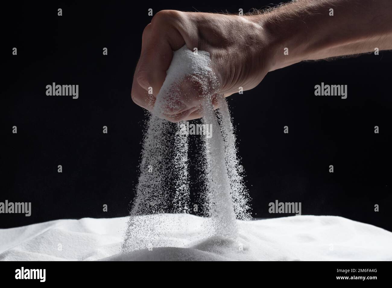 Sand flowing through hand hi-res stock photography and images - Alamy