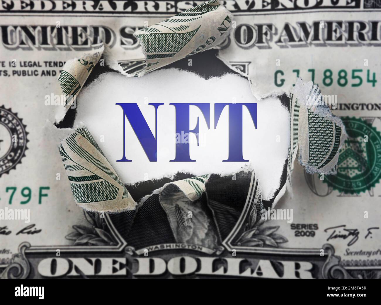 NFT ( Non-Fungible Token ) text in a torn dollar bill Stock Photo - Alamy