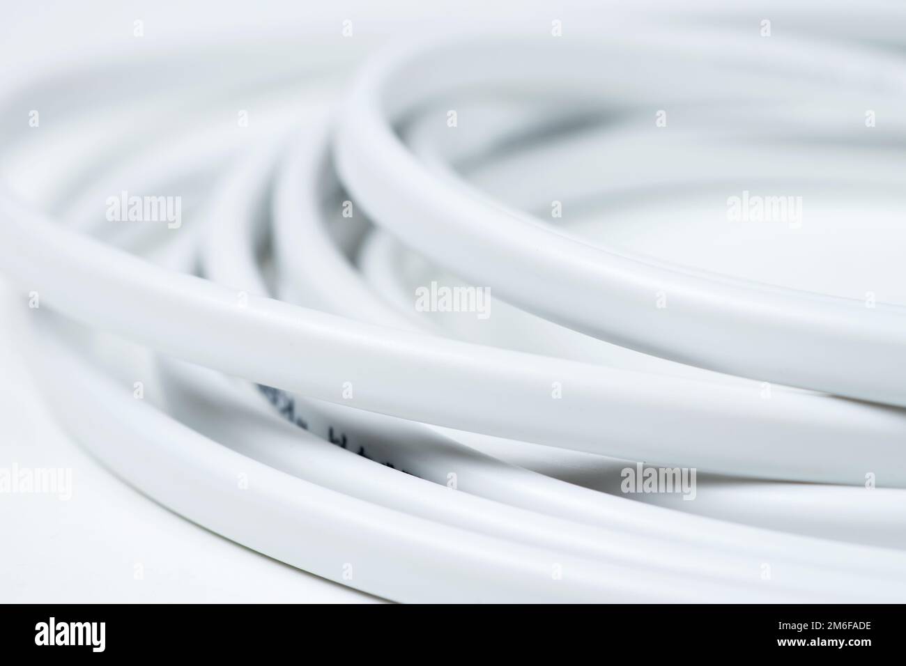 closeup of a white electric cable on a white background Stock Photo - Alamy