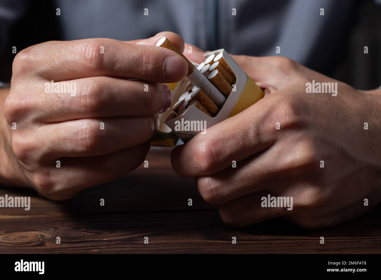 close up man hand holding peel it off cigarette pack prepare smoking a ...