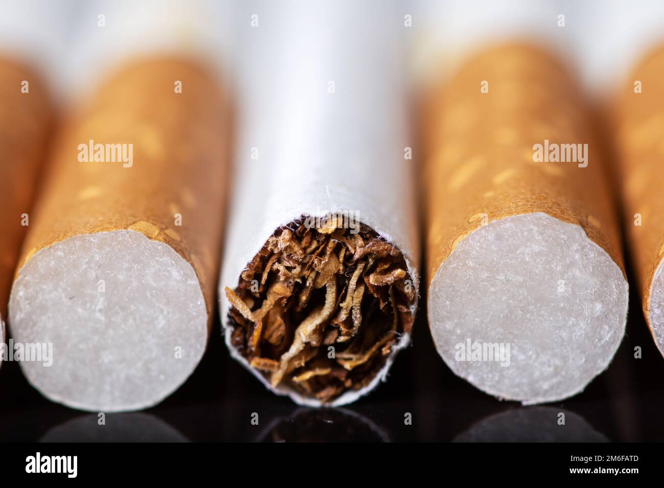 Tobacco in cigarettes with a brown filter close up Stock Photo - Alamy