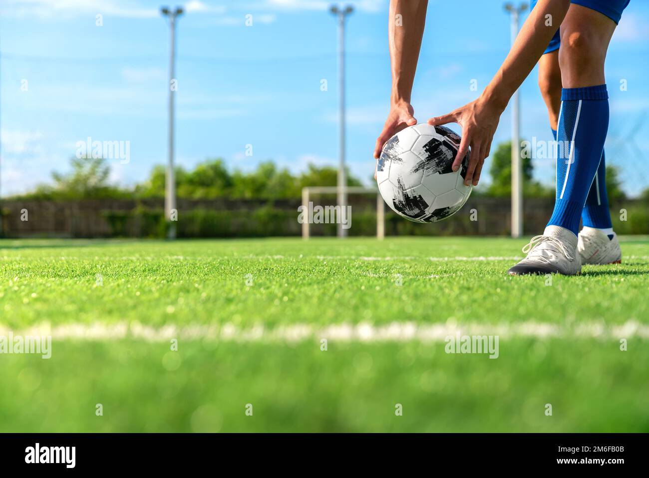 professional football or soccer player kick and shoot ball at penalty ...