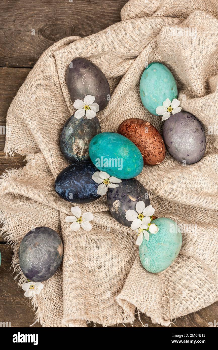 Easter eggs and blooming cherry on old wooden background. Festive ...