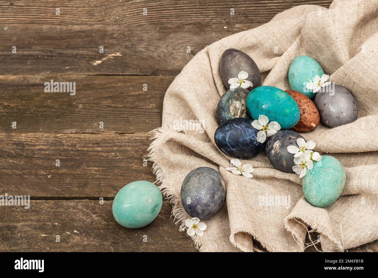Easter eggs and blooming cherry on old wooden background. Festive ...