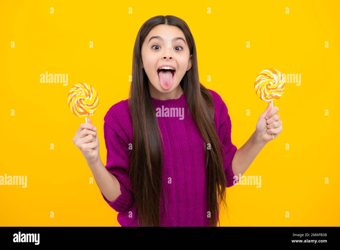 Funny face. Hipster teenager child girl lick lollypop. Sugar nutrition ...