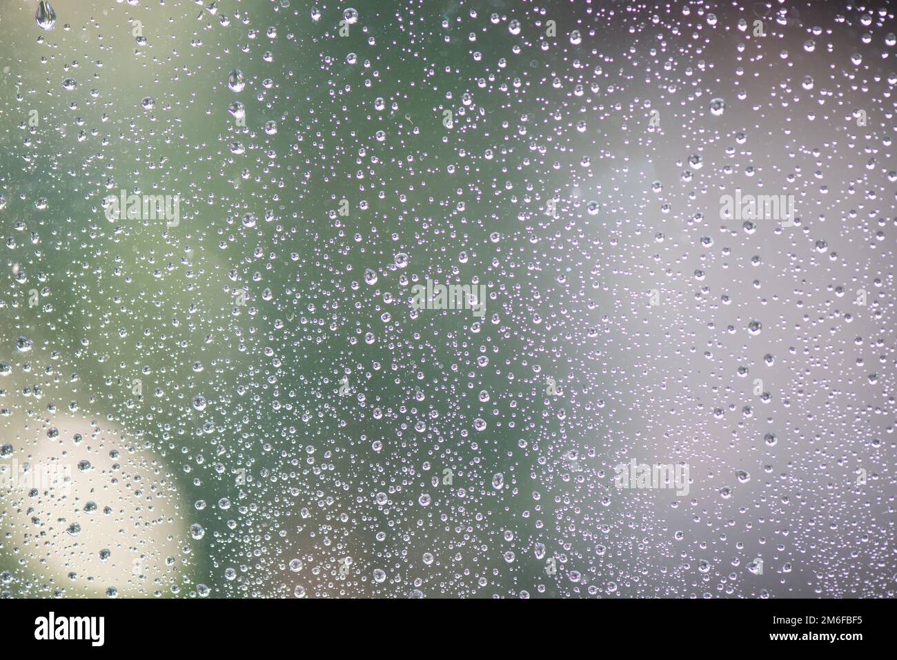 Drops of rain on window with abstract lights Stock Photo - Alamy