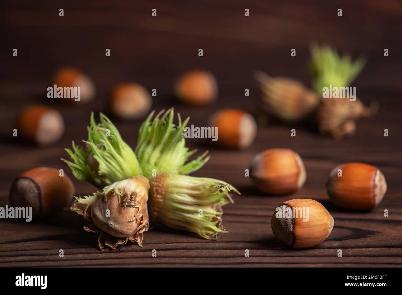 Organic fresh hazelnut on wooden background close up Stock Photo - Alamy