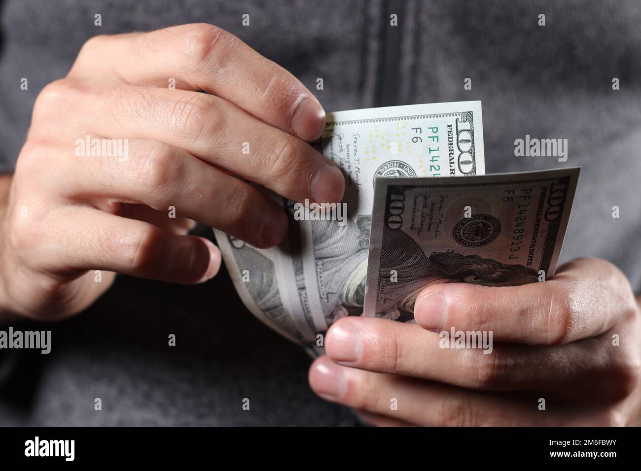 American 100 dollars bank note in hand close up Stock Photo - Alamy