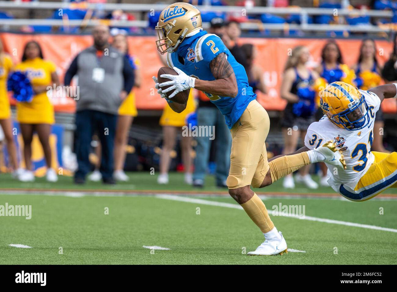 UCLA Bruins wide receiver Titus Mokiao-Atimalala (2) reaches for the ...