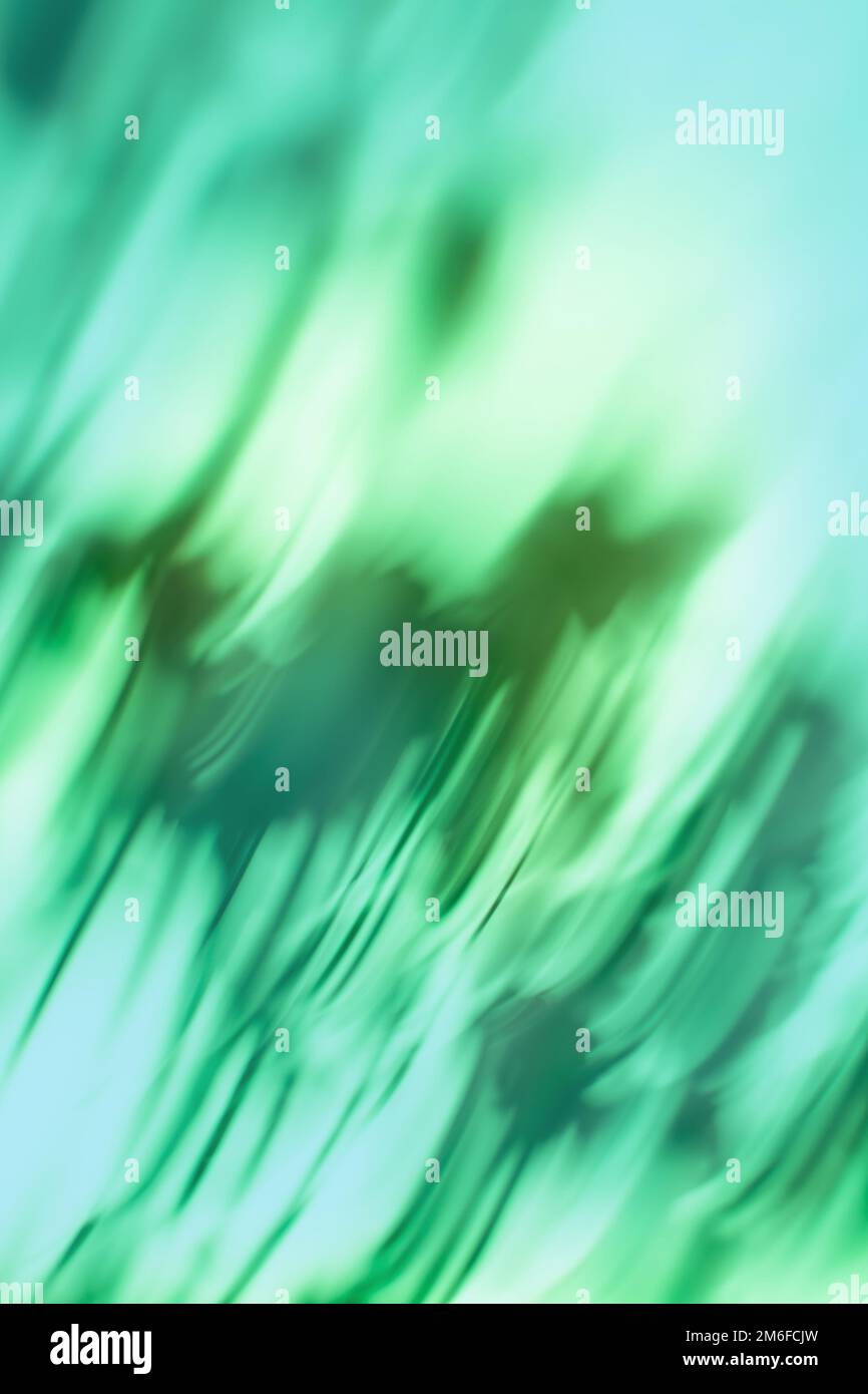 Green dynamic curving light trails. Green blurry defocused dynamic ...