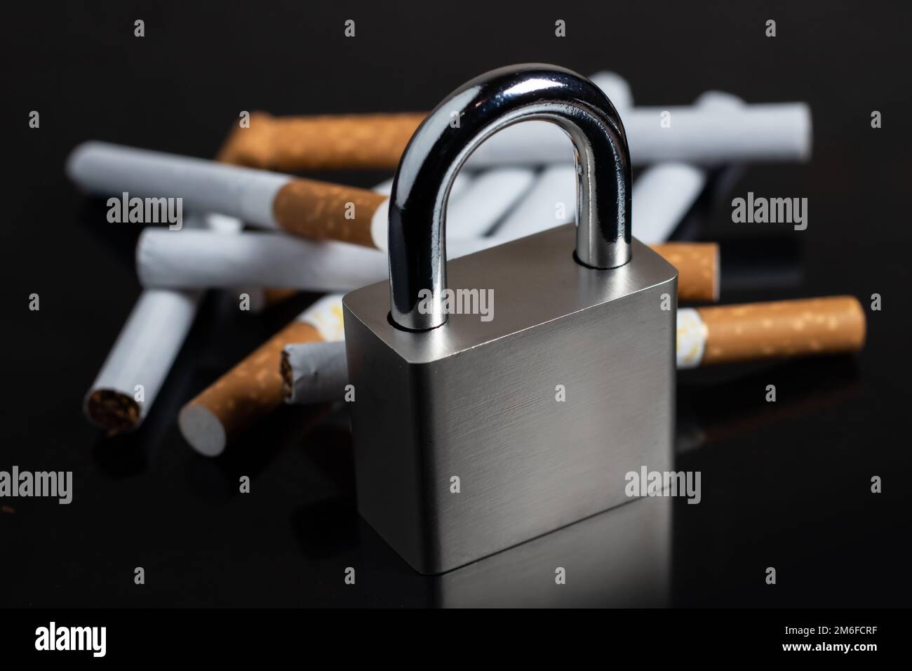 Cigarettes with padlock. Concept stop smoking. close up Stock Photo - Alamy