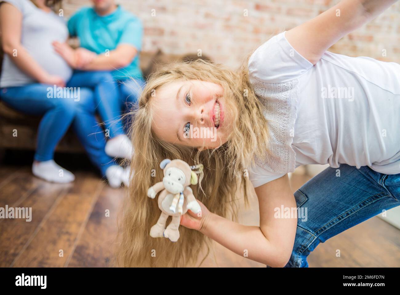 Little girl fooling around in front of the camera Stock Photo - Alamy