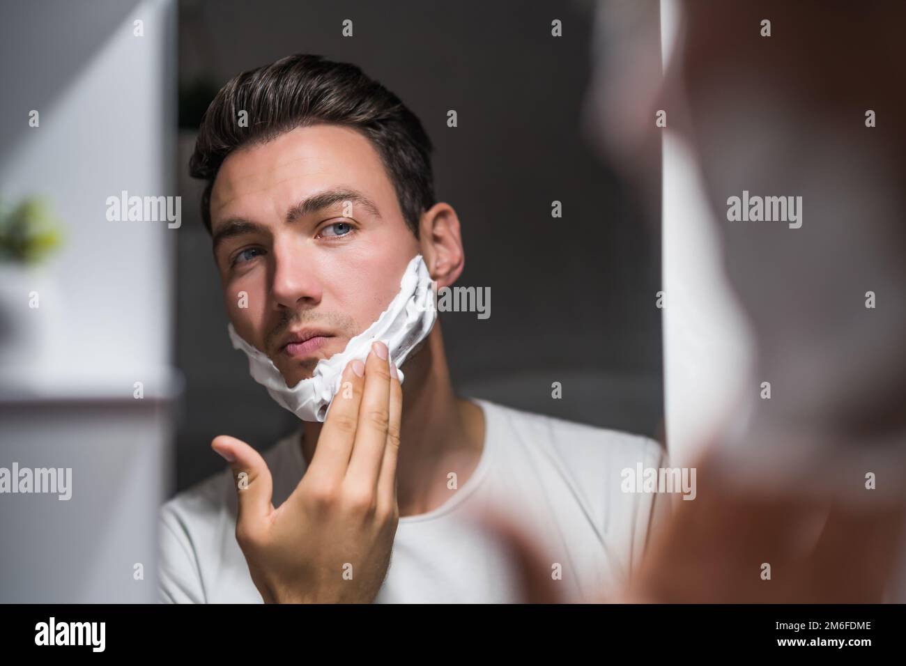 Young man shaving himself close hi-res stock photography and images - Alamy