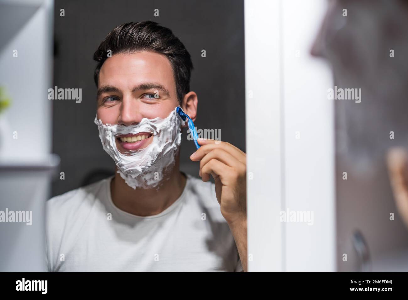 Young man shaving himself close hi-res stock photography and images - Alamy