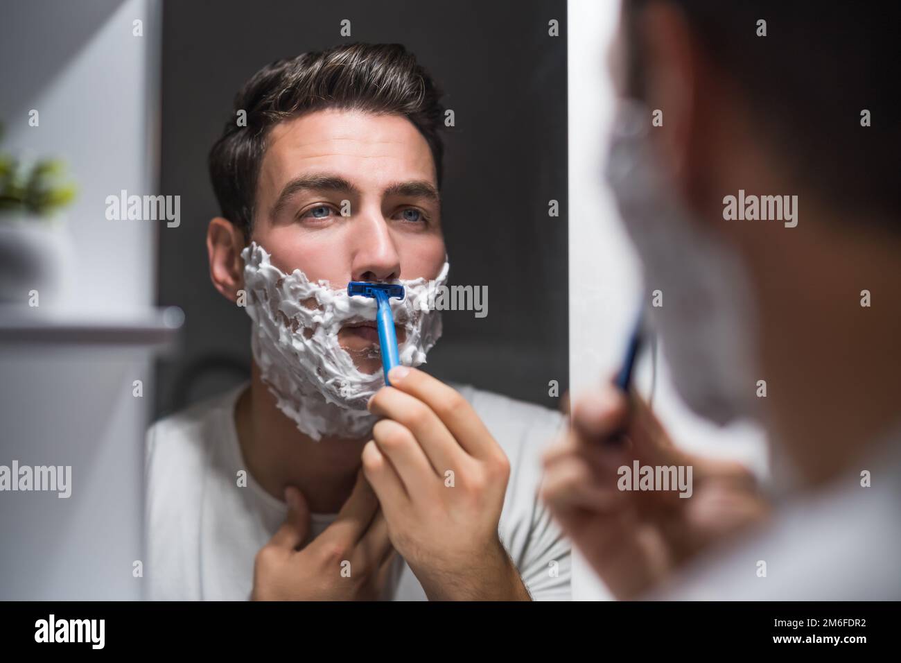 Young man shaving himself close hi-res stock photography and images - Alamy