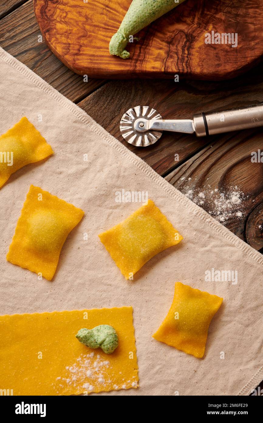 Raw homemade ravioli pasta with spinach and ricotta Stock Photo - Alamy