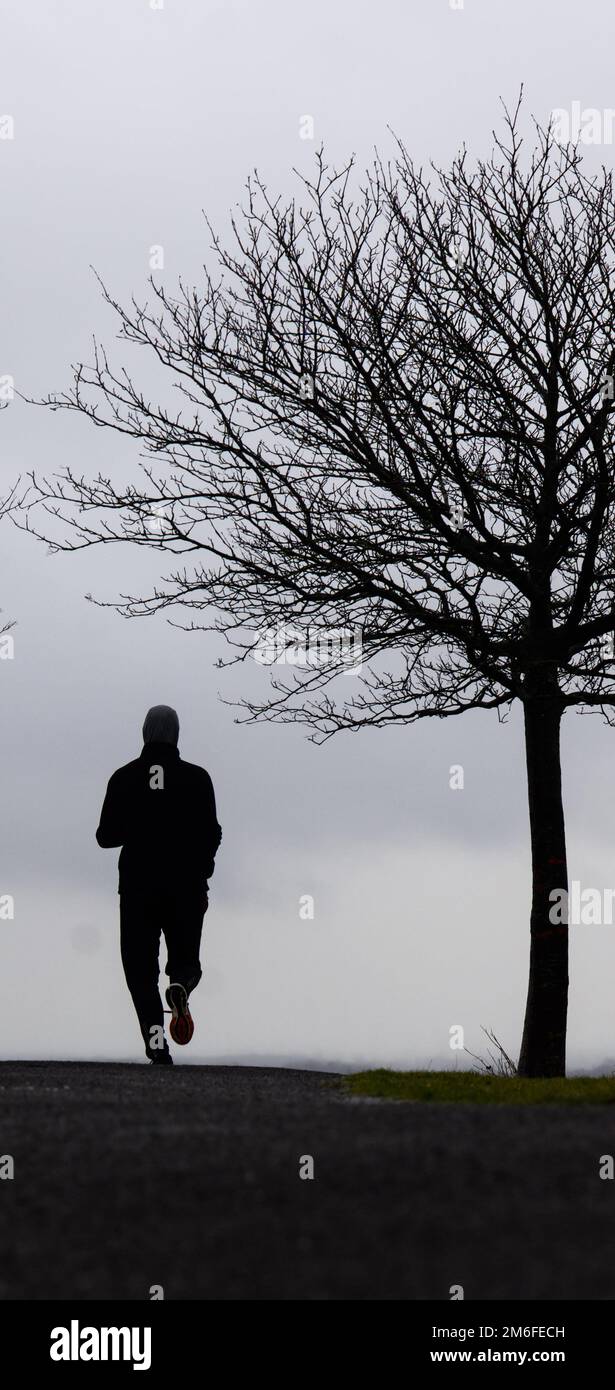 Hanover, Germany. 04th Jan, 2023. A man jogs in stormy rainy weather at ...