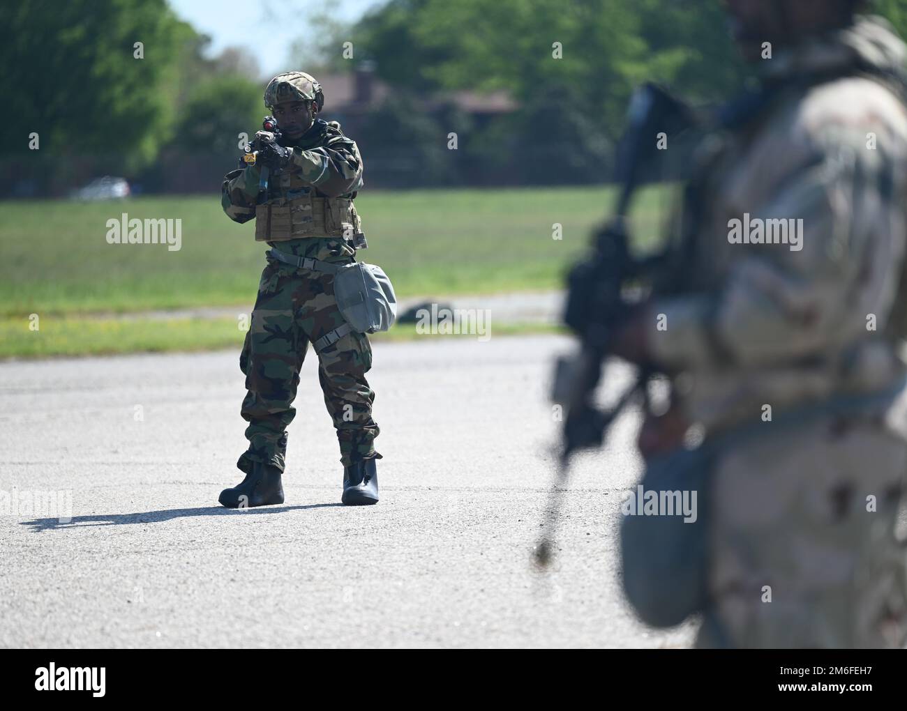 Airmen from the 633d Security Forces Squadron practice proper procedures in a simulated ...