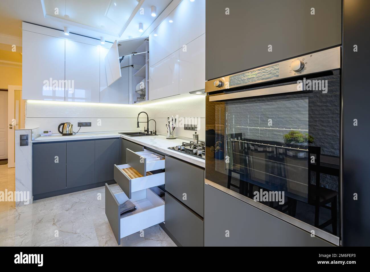 Luxury white and dark grey modern kitchen interior Stock Photo - Alamy