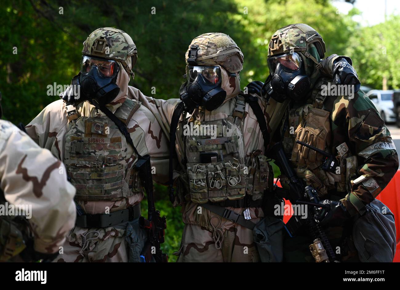 Airmen from the 633d Security Forces Squadron practice self-aid buddy care in a simulated attack ...