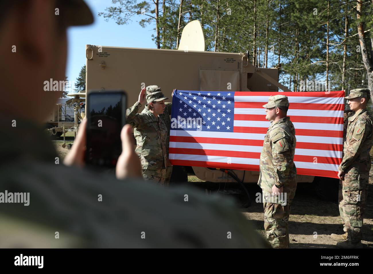 U.S. Army Sgt. Christopher Putnam’s spouse views the oath of enlistment ...