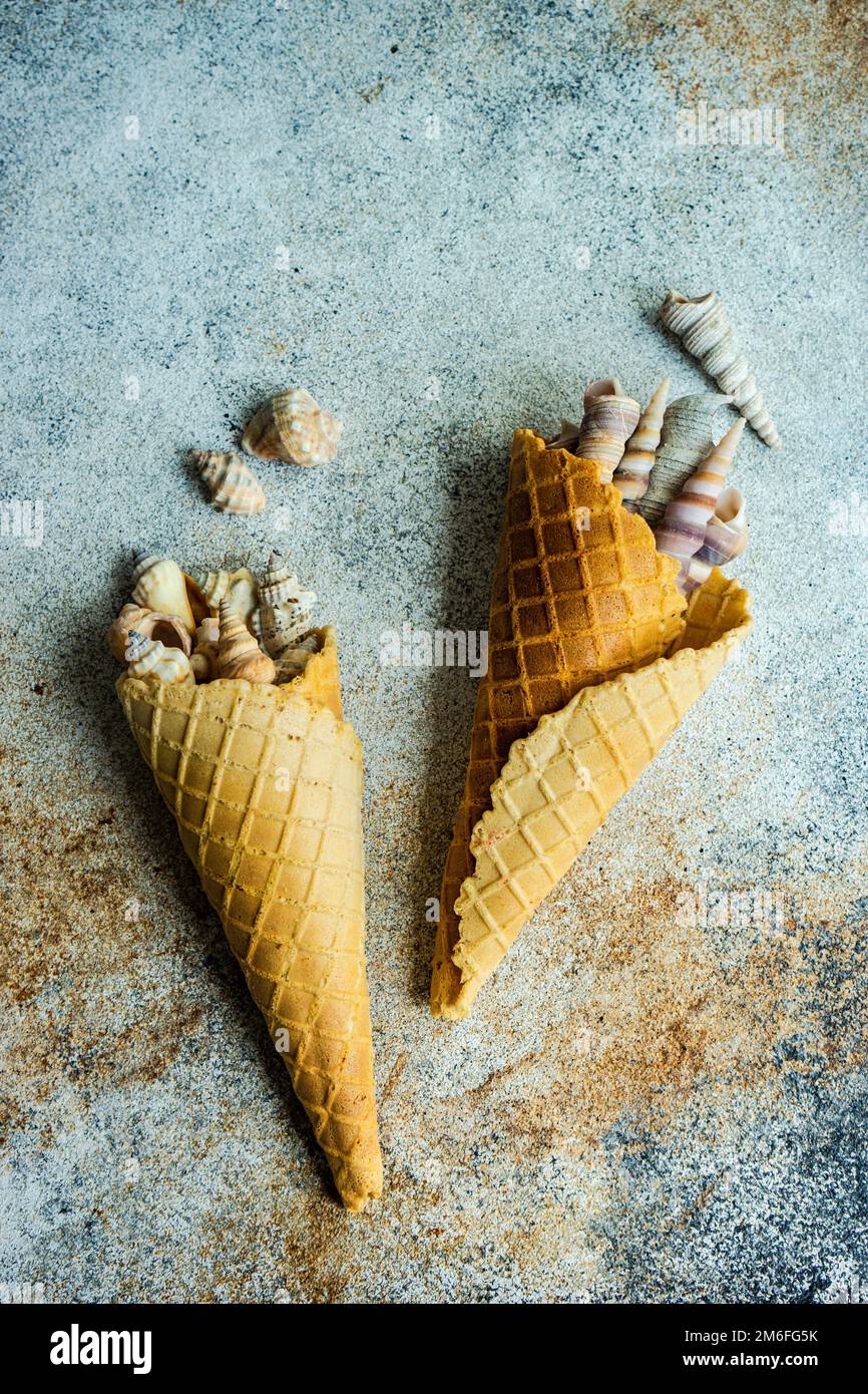 Summer background with waffle cones full of sea shells Stock Photo - Alamy