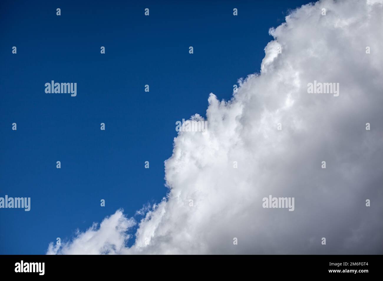 Big white clouds in a blue sky close-up. There is a place for the text ...