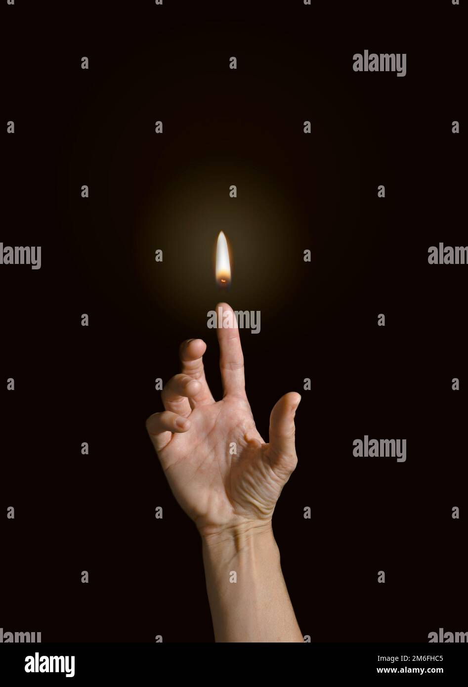 A finger holding a flame Stock Photo - Alamy