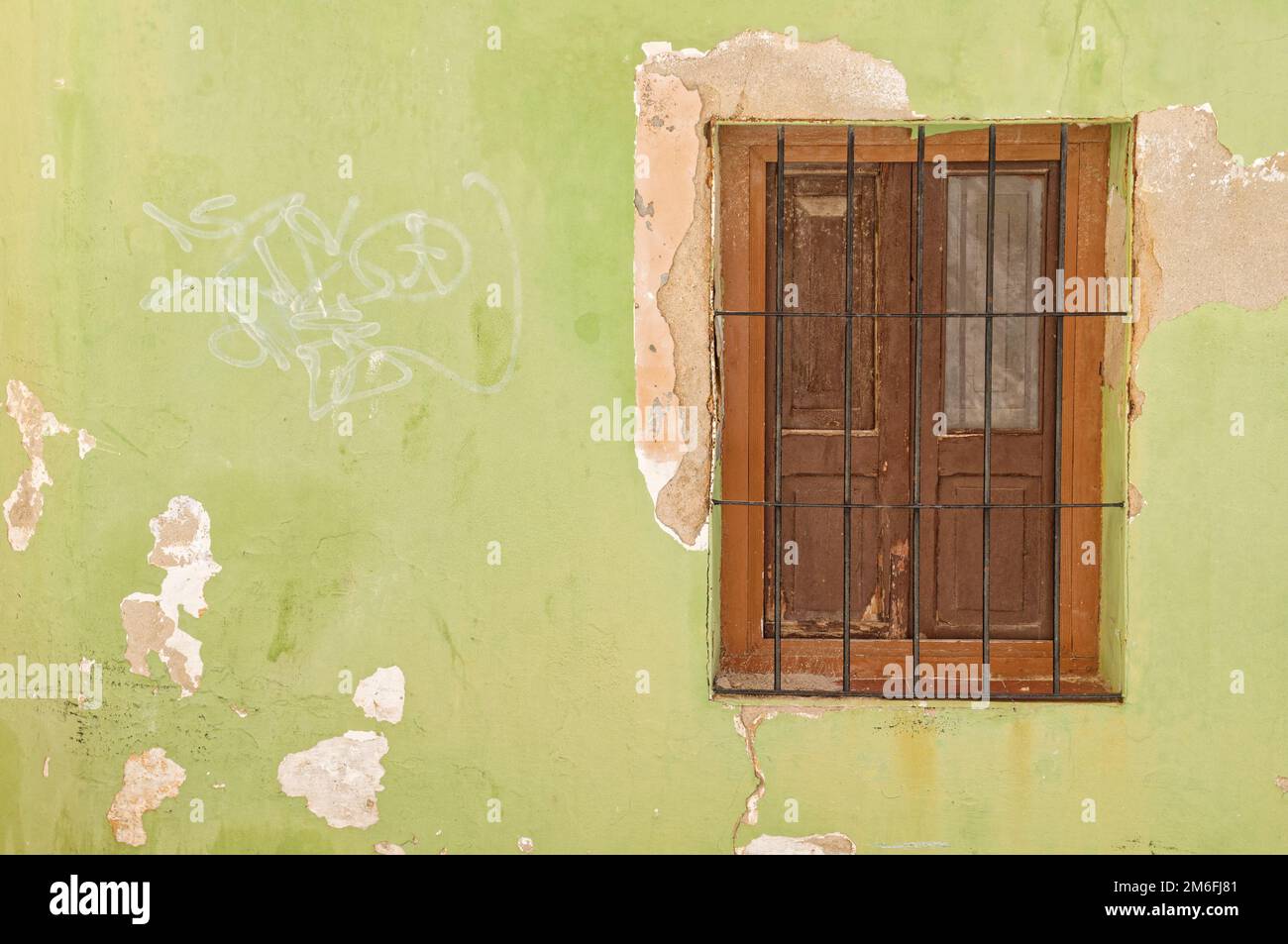 A view of the exterior of an aged building with chipped paint on the ...