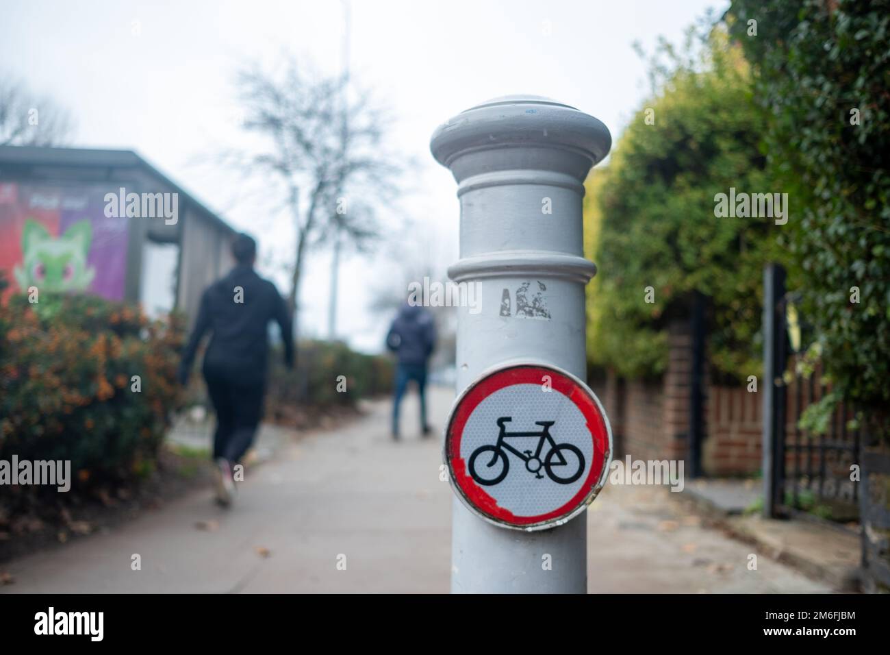 Cycle path sign and people walking to work in south west London Stock ...