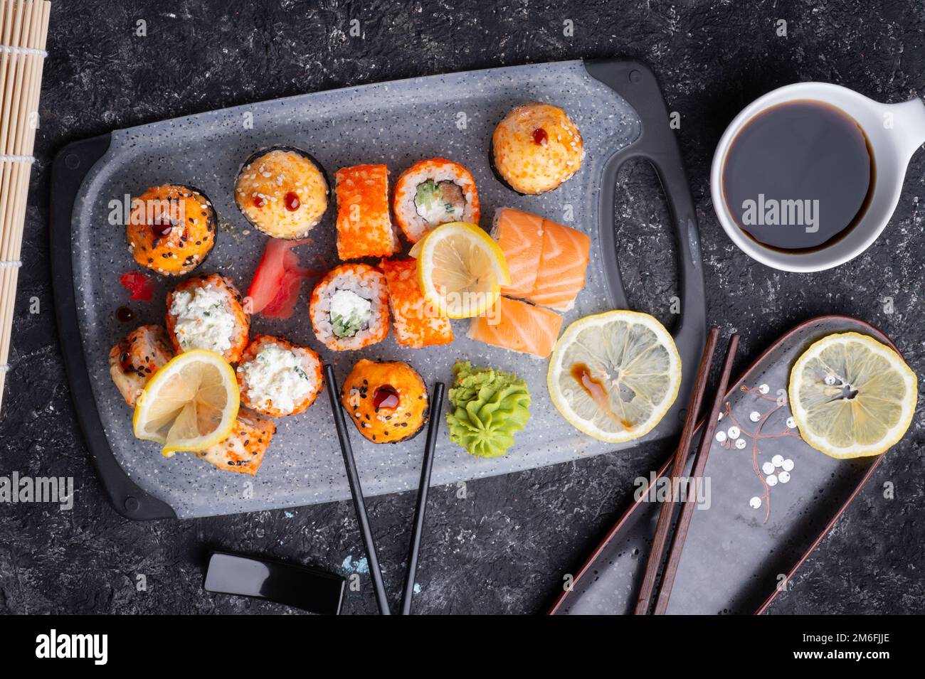 Sushi roll set served at grey tray at black table. flat lay. close up ...