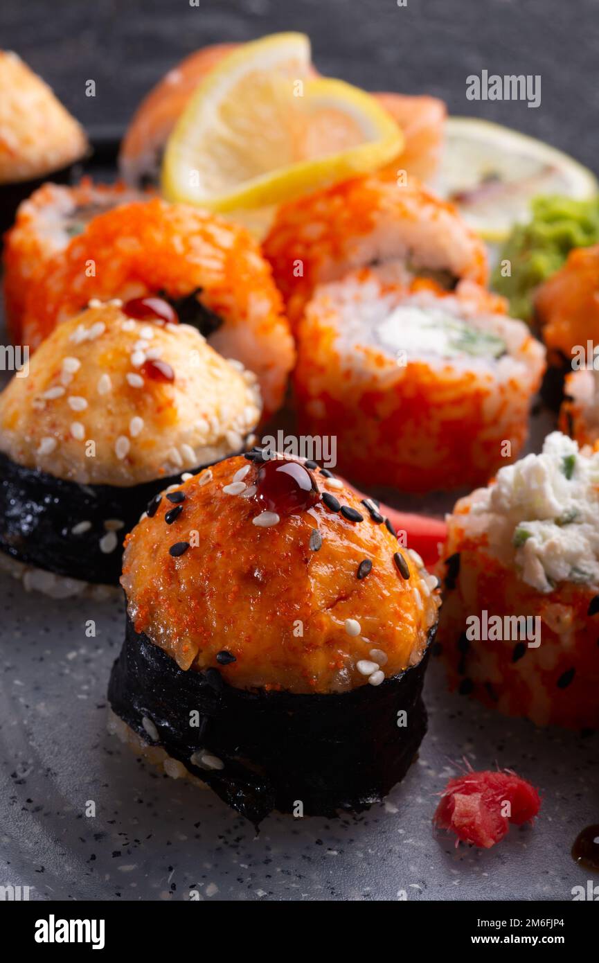 Sushi roll set served at grey tray at black table. flat lay. close up ...
