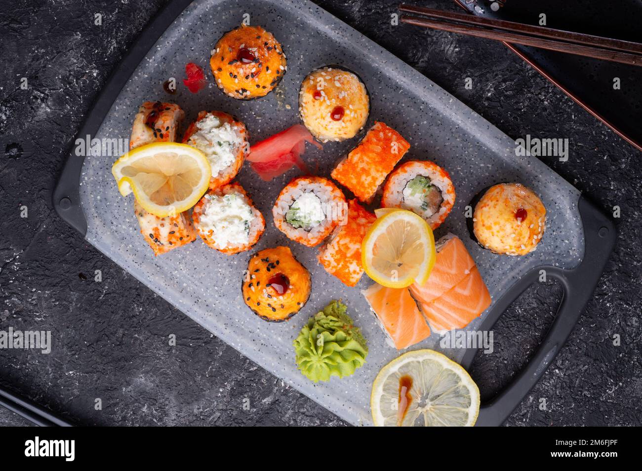 Sushi roll set served at grey tray at black table. flat lay Stock Photo ...