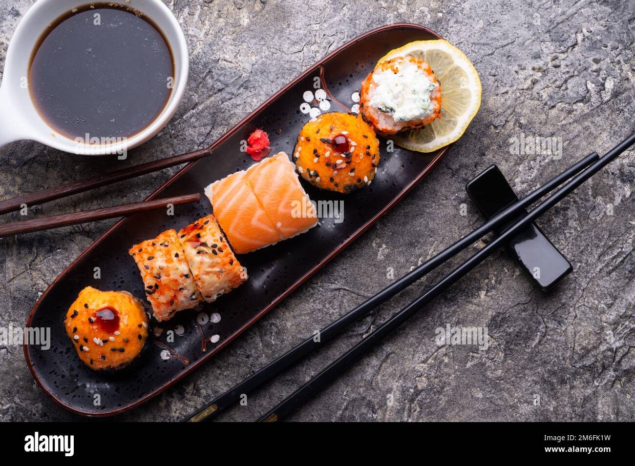 Sushi roll set served at black tray at grey table. flat lay Stock Photo ...