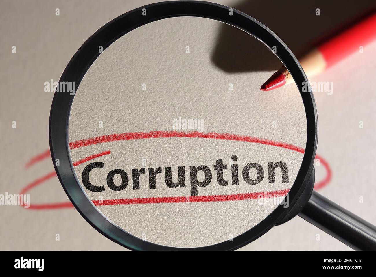 Corruption text circled in red pencil with magnifying glass Stock Photo ...