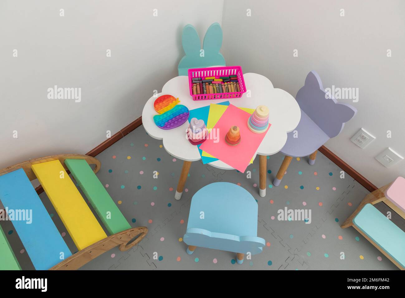 Top view of a children's work table in a pediatric office, with crayons ...