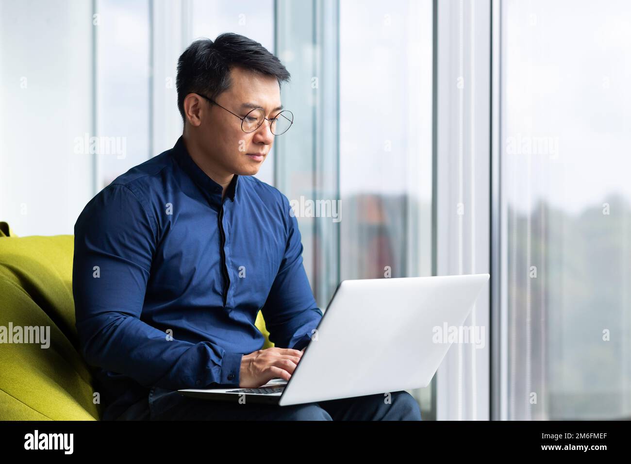 Serious and focused engineer developer programmer writing code using ... Serious and focused engineer developer programmer writing code using ...