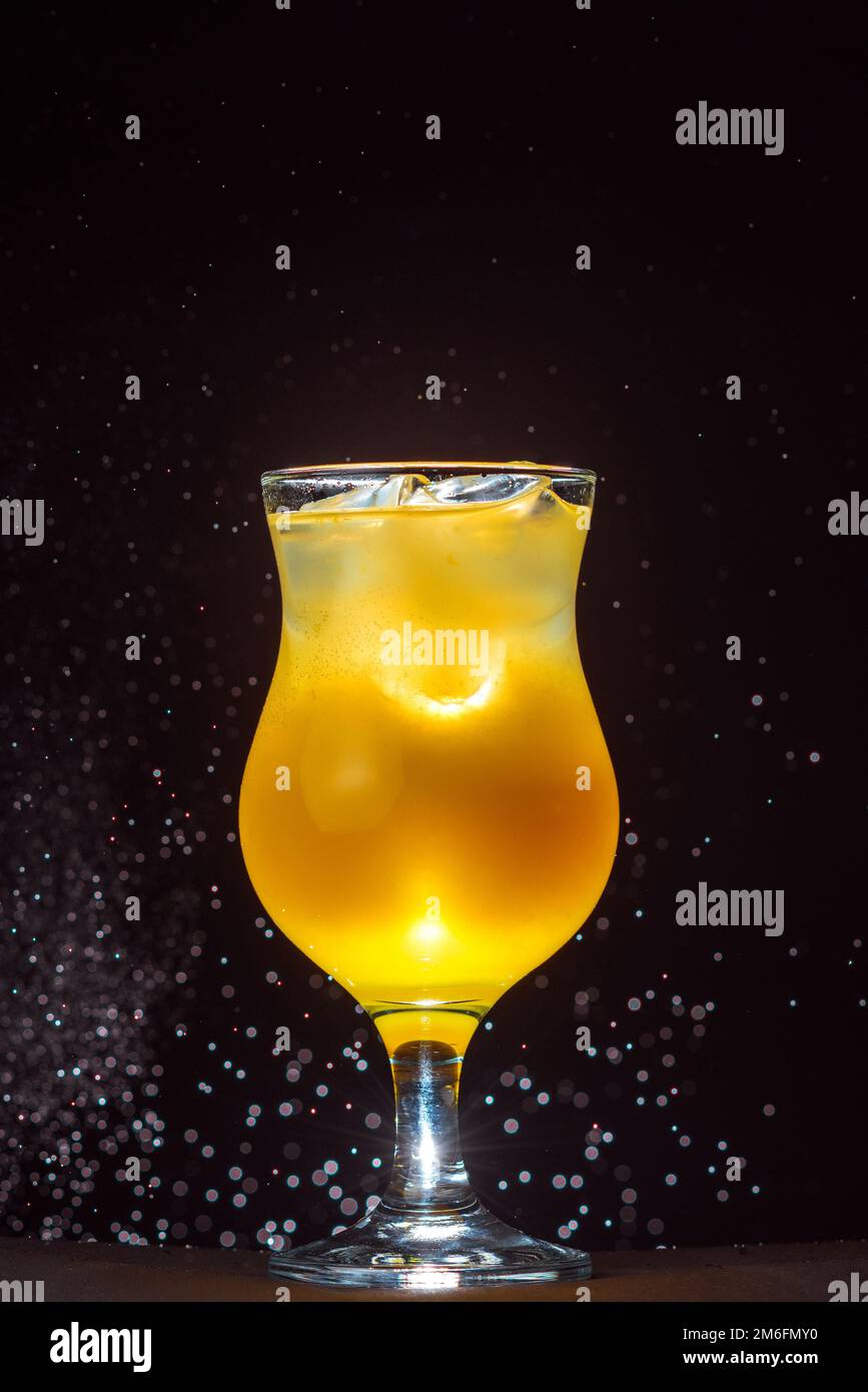 alcoholic cocktail in a glass container on the background of a black ...