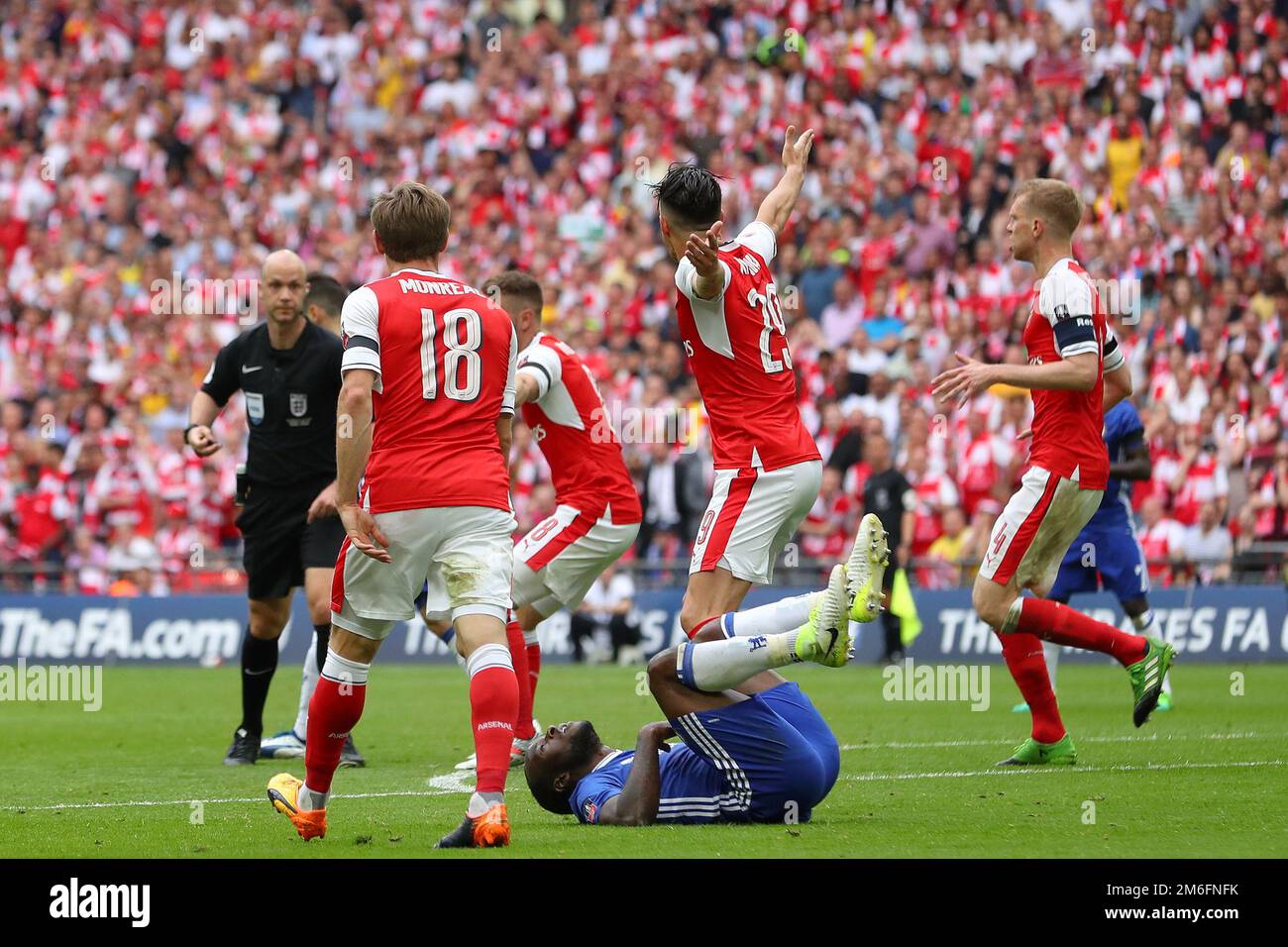 Arsenal players react toward Referee, Anthony Taylor after Victor Moses ...