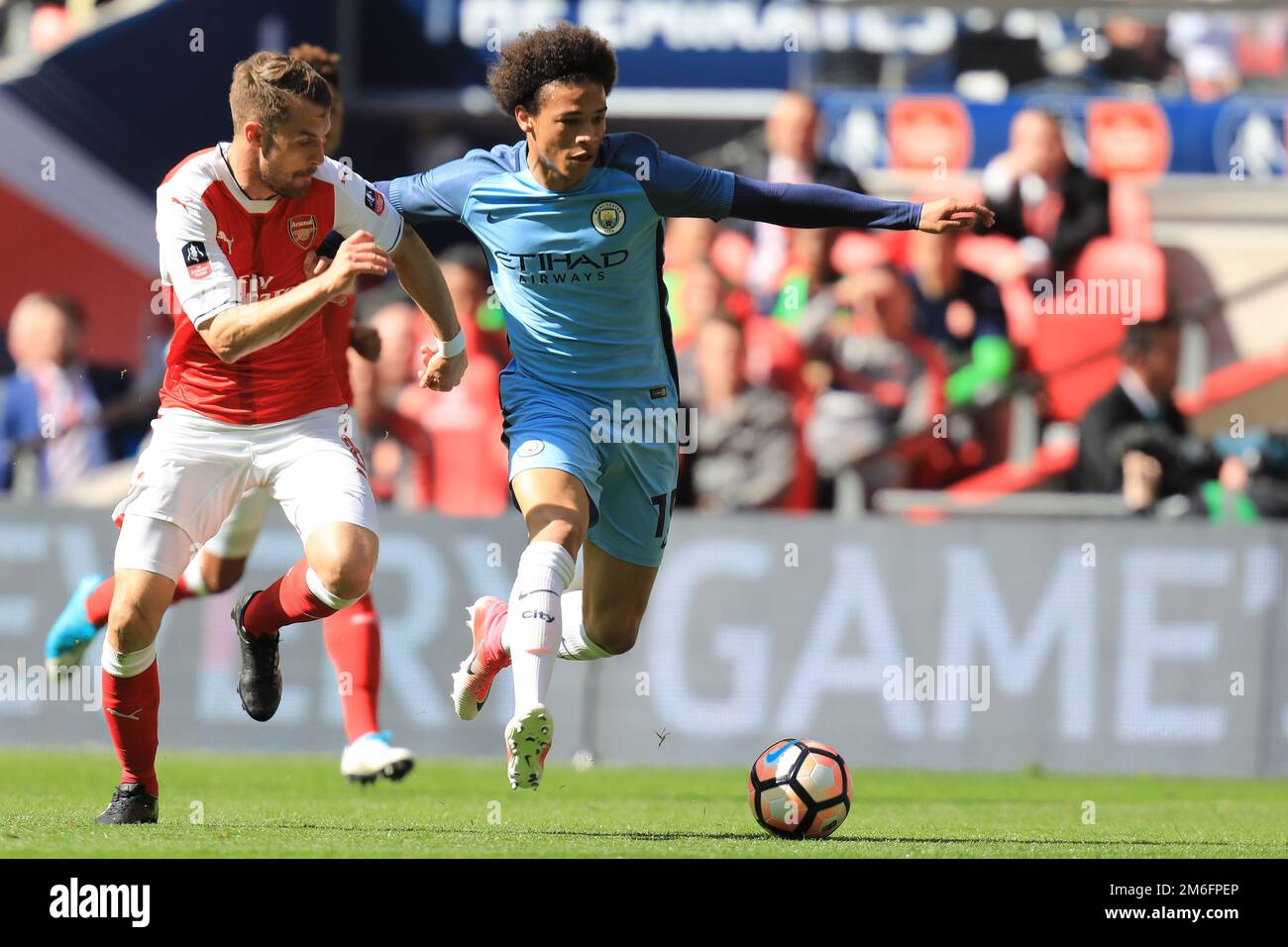 Leroy Sane of Manchester City battles with Aaron Ramsey of Arsenal ...