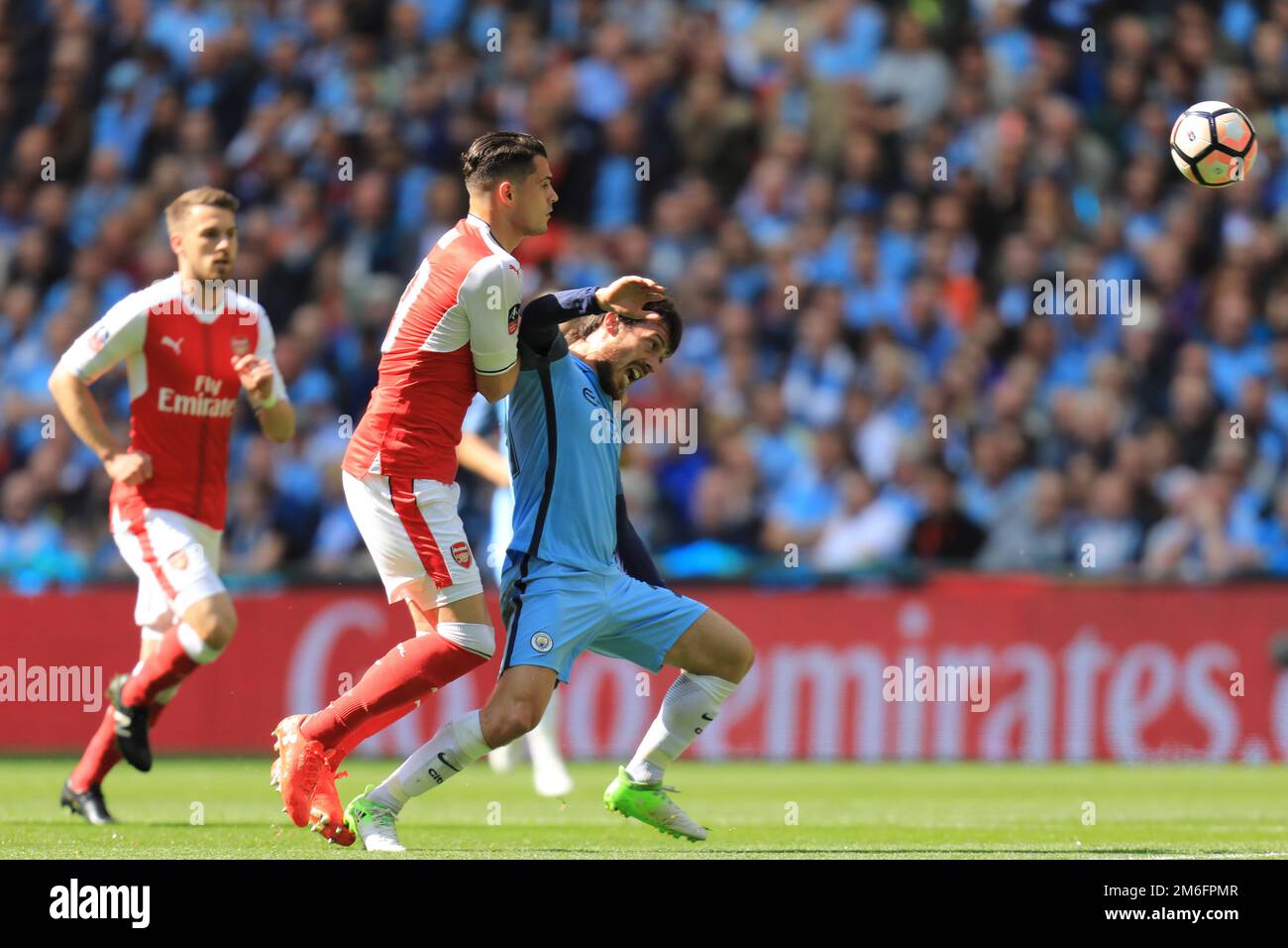 Granit Xhaka of Arsenal battles with David Silva of Manchester City ...