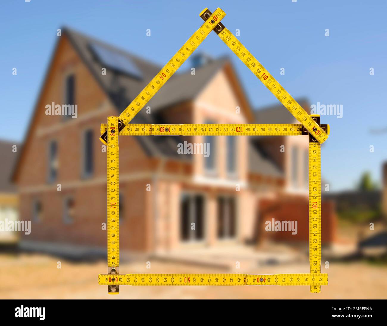 House construction in shell with meter stick as symbol Stock Photo - Alamy