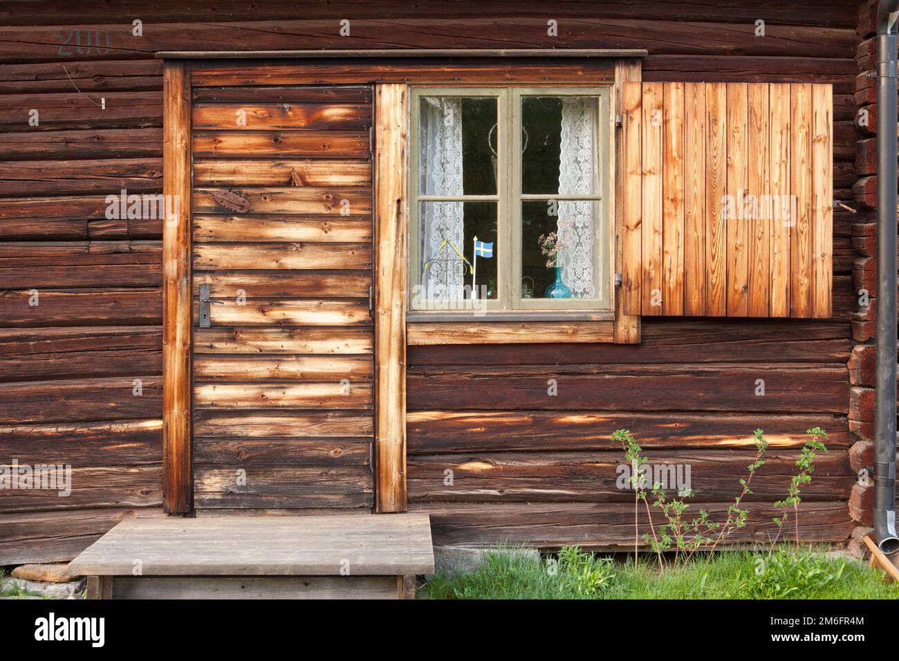 Old wooden, timber buildings in a village. Wall, entry and window ...