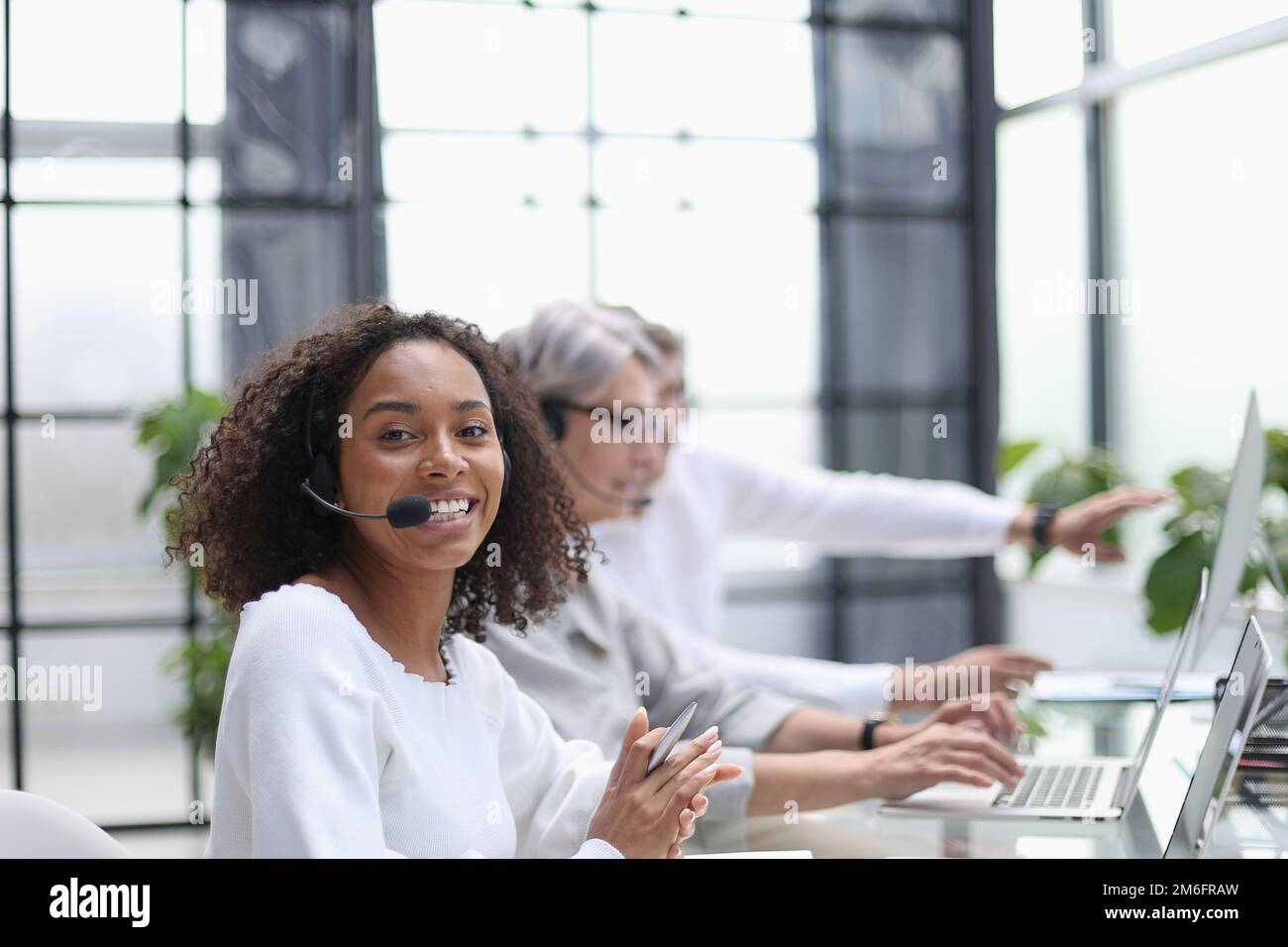 african american operator smiling in a call center Stock Photo - Alamy