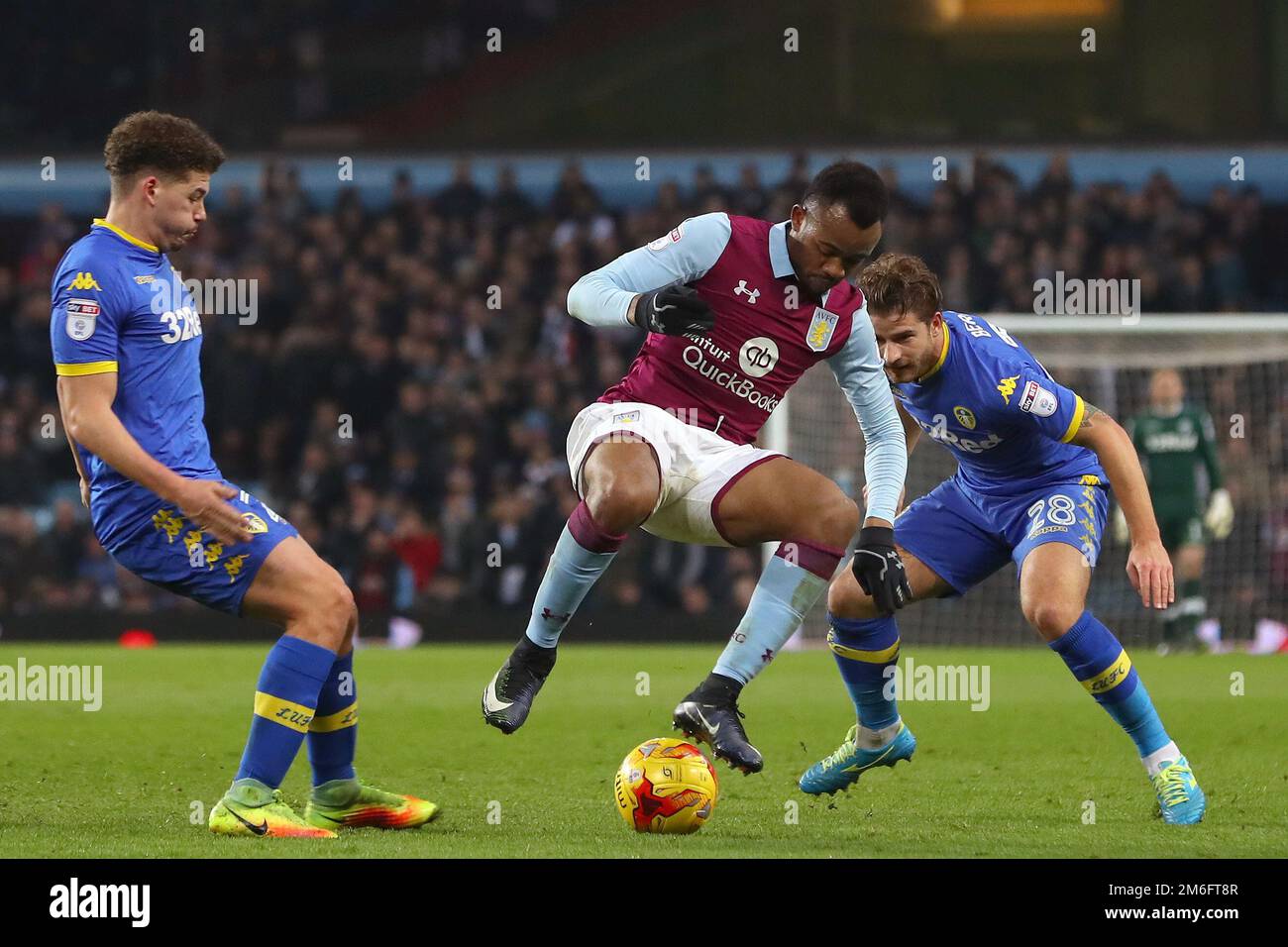 Jordan Ayew of Aston Villa controls the ball under pressure from ...