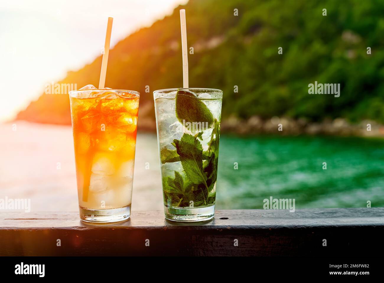 Glasses of Mai Tai and Mojito cocktails on the beach Stock Photo - Alamy