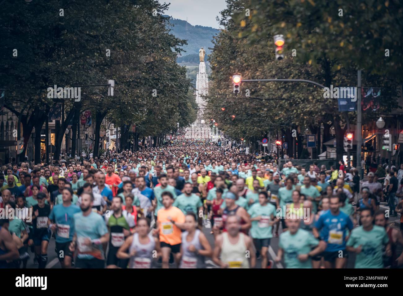Many runners in the Bilbao Night Marathon, running in the streets of ...