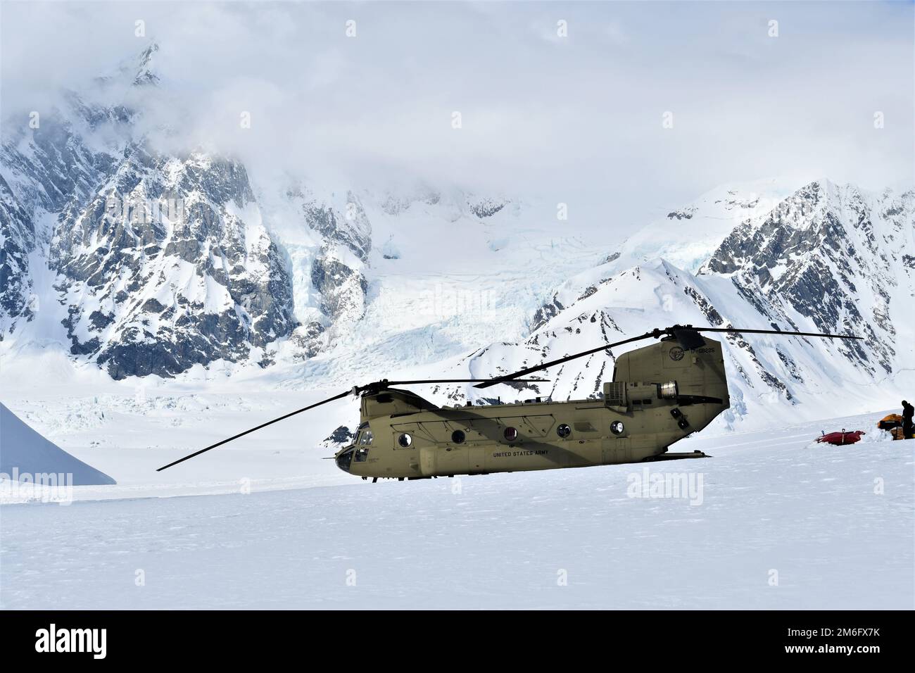 A CH-47F Chinook helicopter is parked on Kahiltna Glacier while the ...